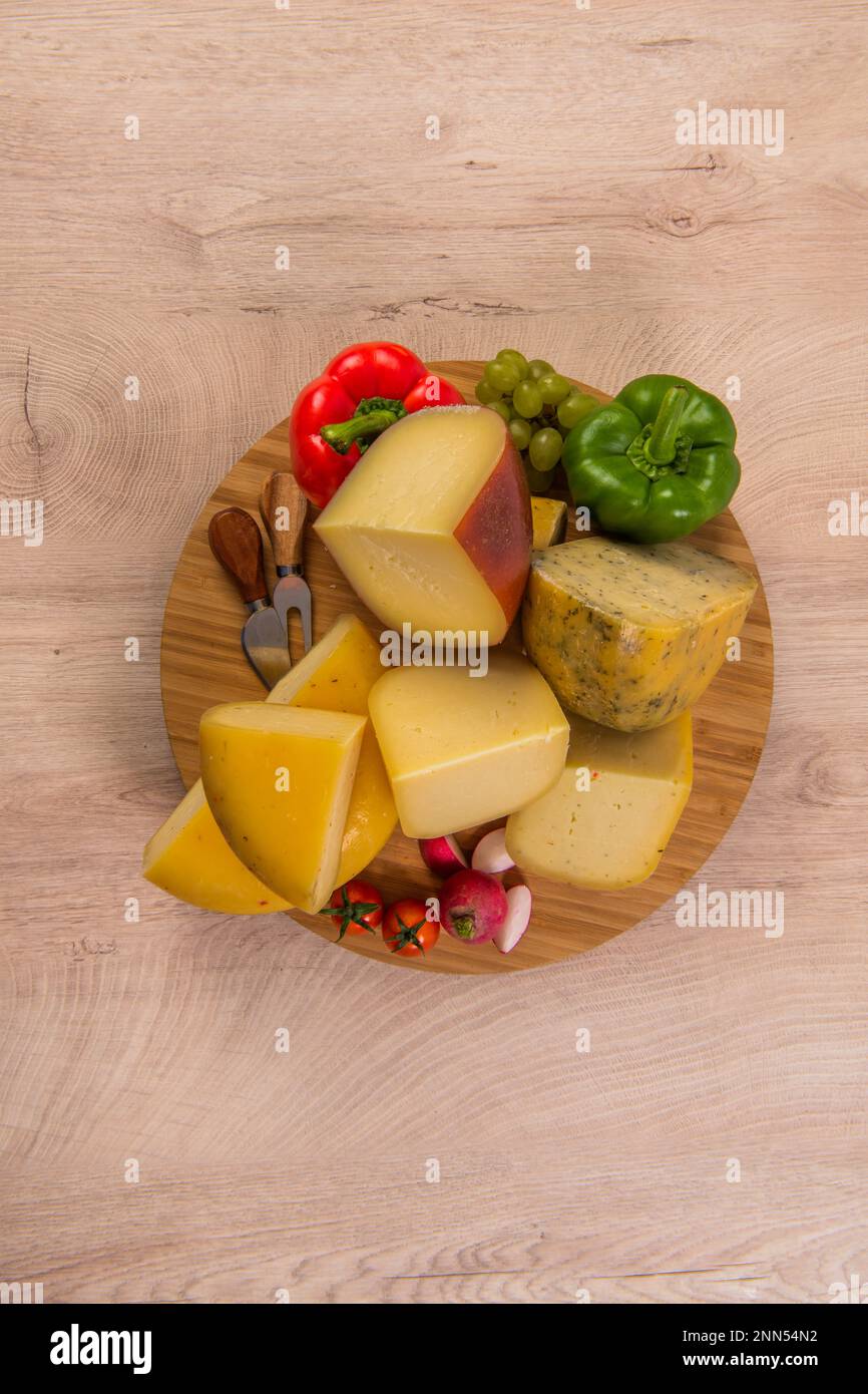 Bosnian traditional cheese served on a wooden container with peppers ...