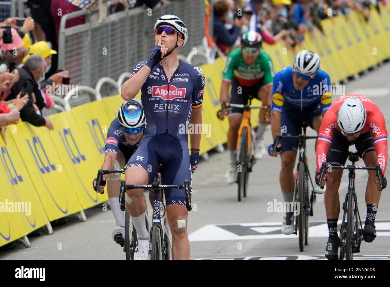 Belgium's Tim Merlier celebrates as he crosses the finish line to win ...
