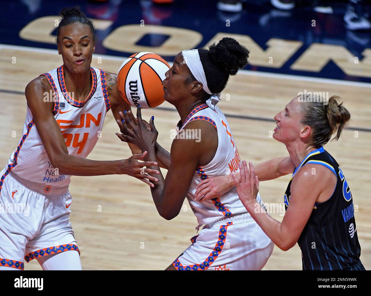 Connecticut Sun center Beatrice Mompremier, center, bobbles the rebound ...