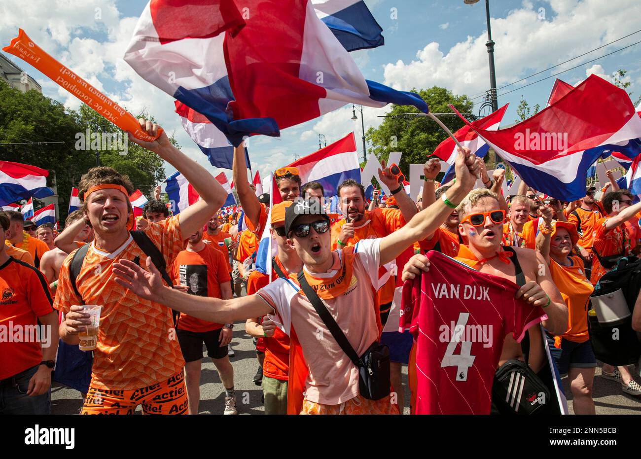 Dutch soccer fans wave national flags as they march to the stadium ...