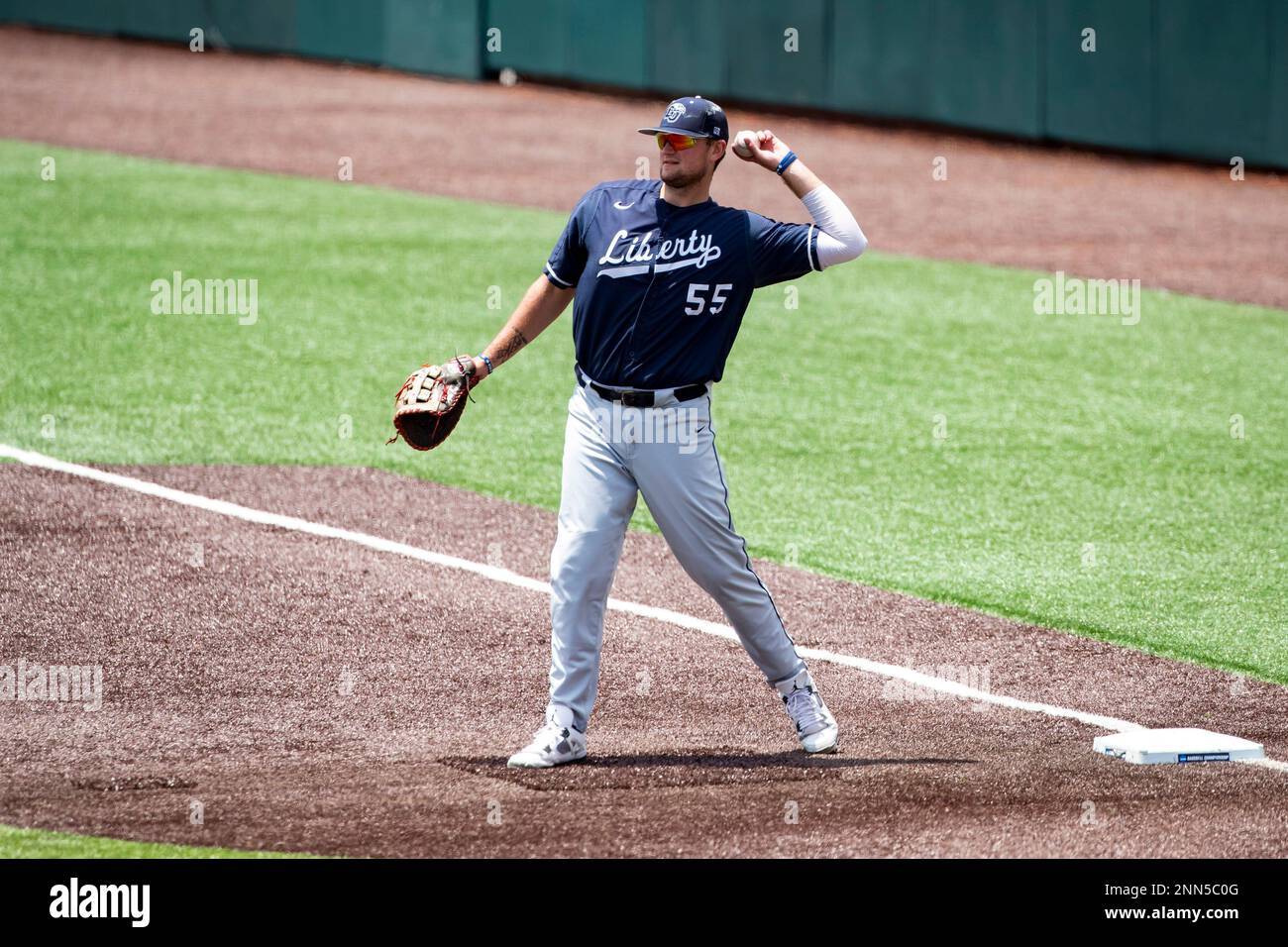 Liberty Flames first baseman Logan Mathieu (55) on defense against the ...