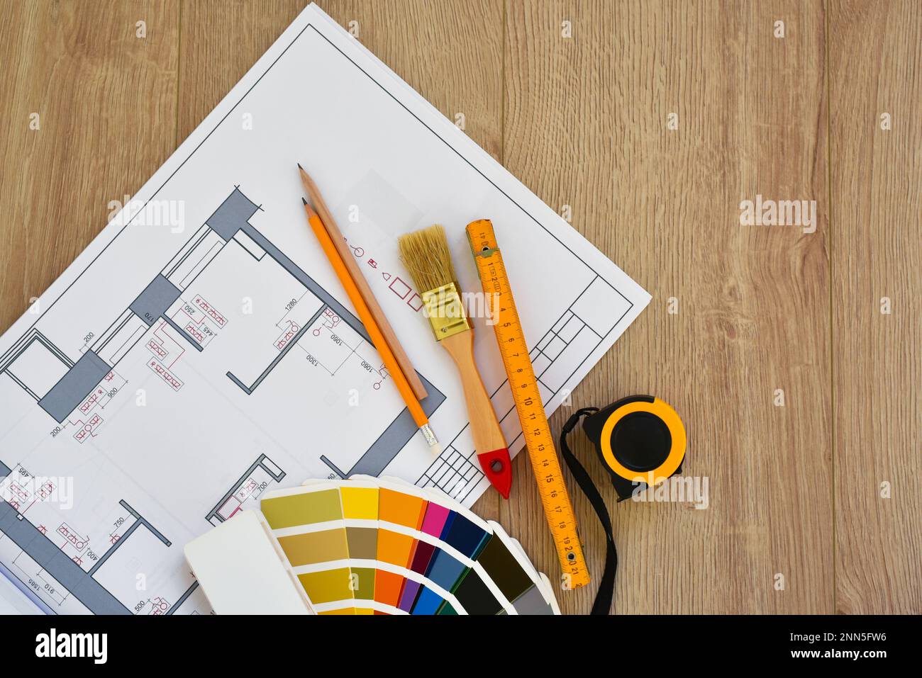 Architectural drawings with color guide, brushes, pencils, ruler on ...