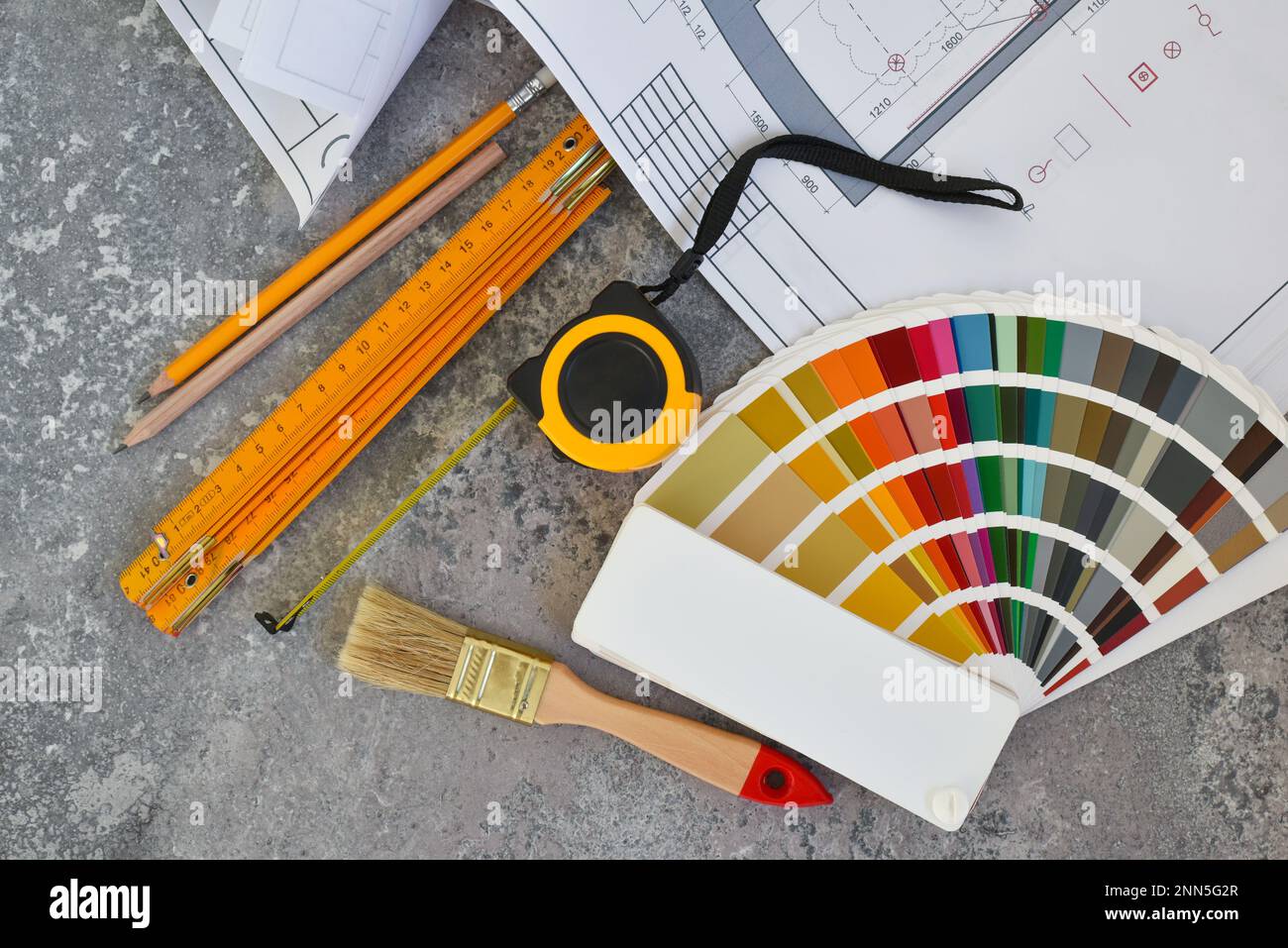 Architectural drawings with color guide, brushes, pencils, ruler on ...