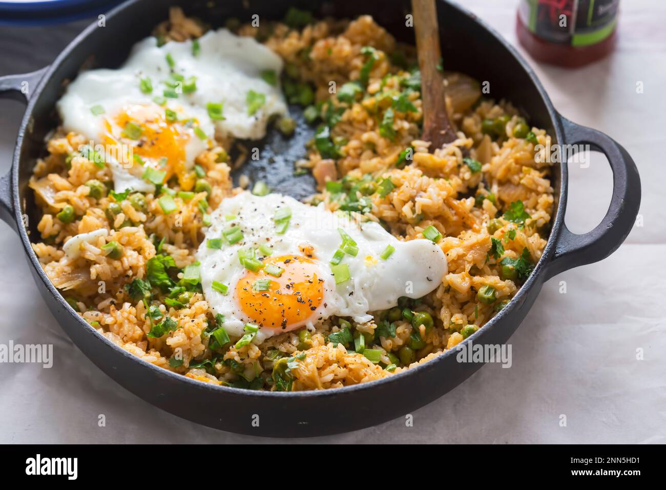 Kimchi fried rice with peas, fried egg and sriracha sauce Stock Photo ...