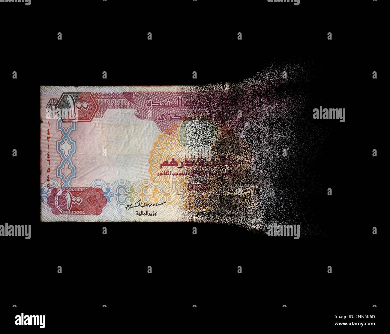 A concept image showing a half dissolved flat Dirham paper bank note on ...