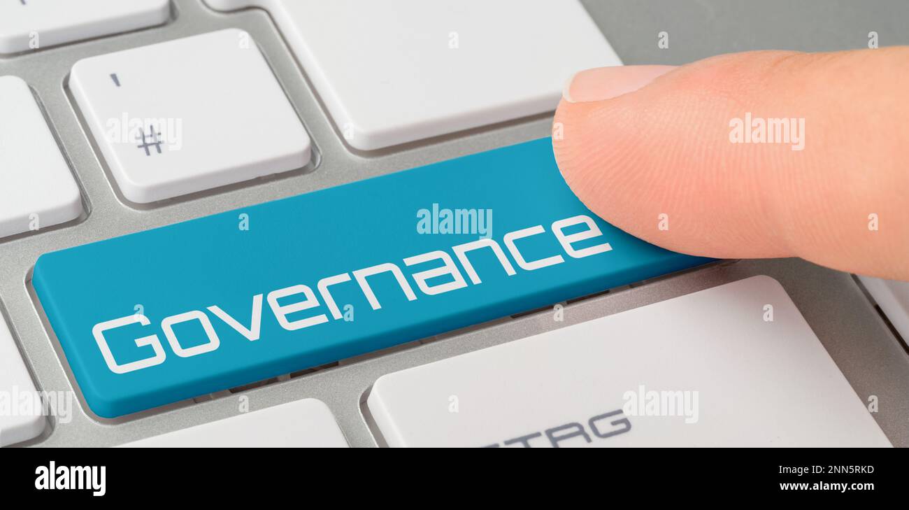 A keyboard with a blue labeled button - Governance Stock Photo - Alamy
