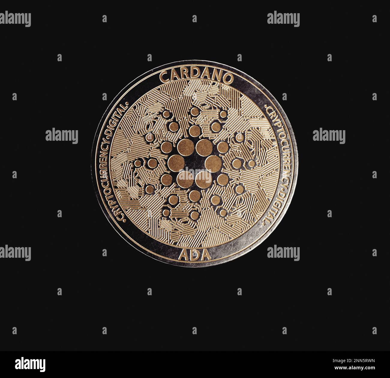 A dimly lit physical cardano cryptocurrency in bronze and silver coin ...