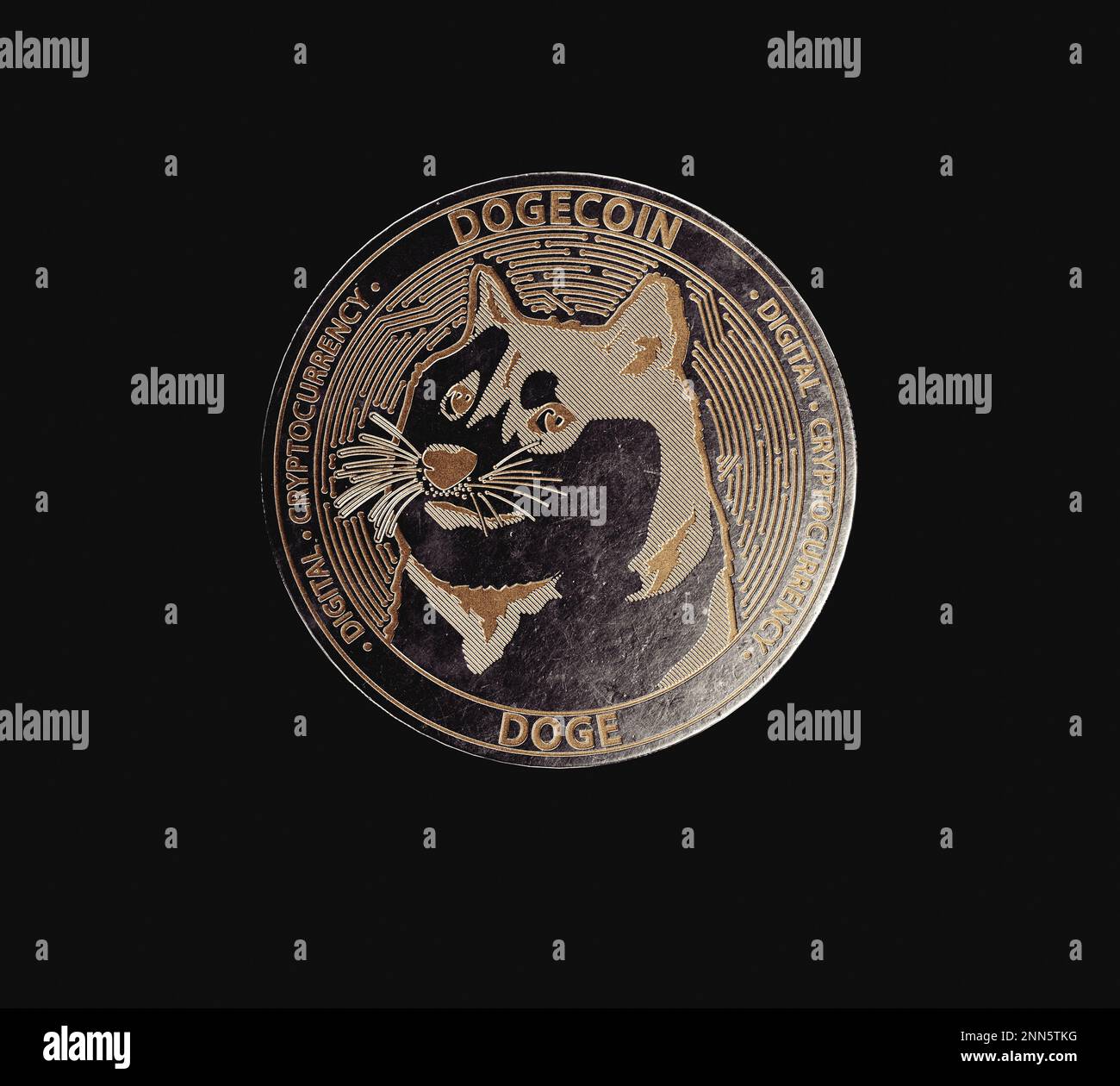 A dimly lit physical doge cryptocurrency in bronze and silver coin form ...