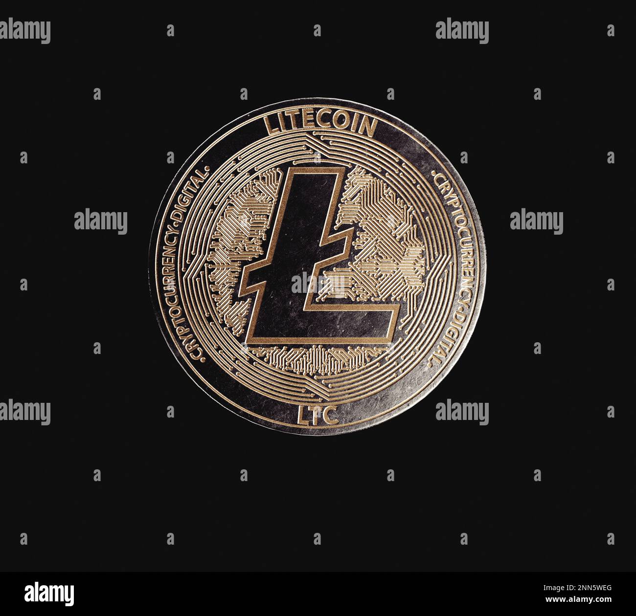 A dimly lit physical Litecoin cryptocurrency in bronze and silver coin ...