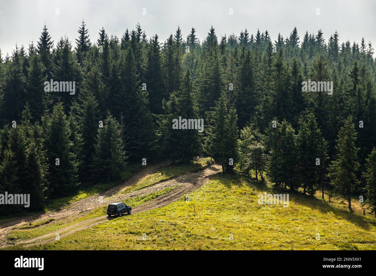 Old retro vintage 4x4 SUV on a dirt gravel dirt road in summer. Off ...