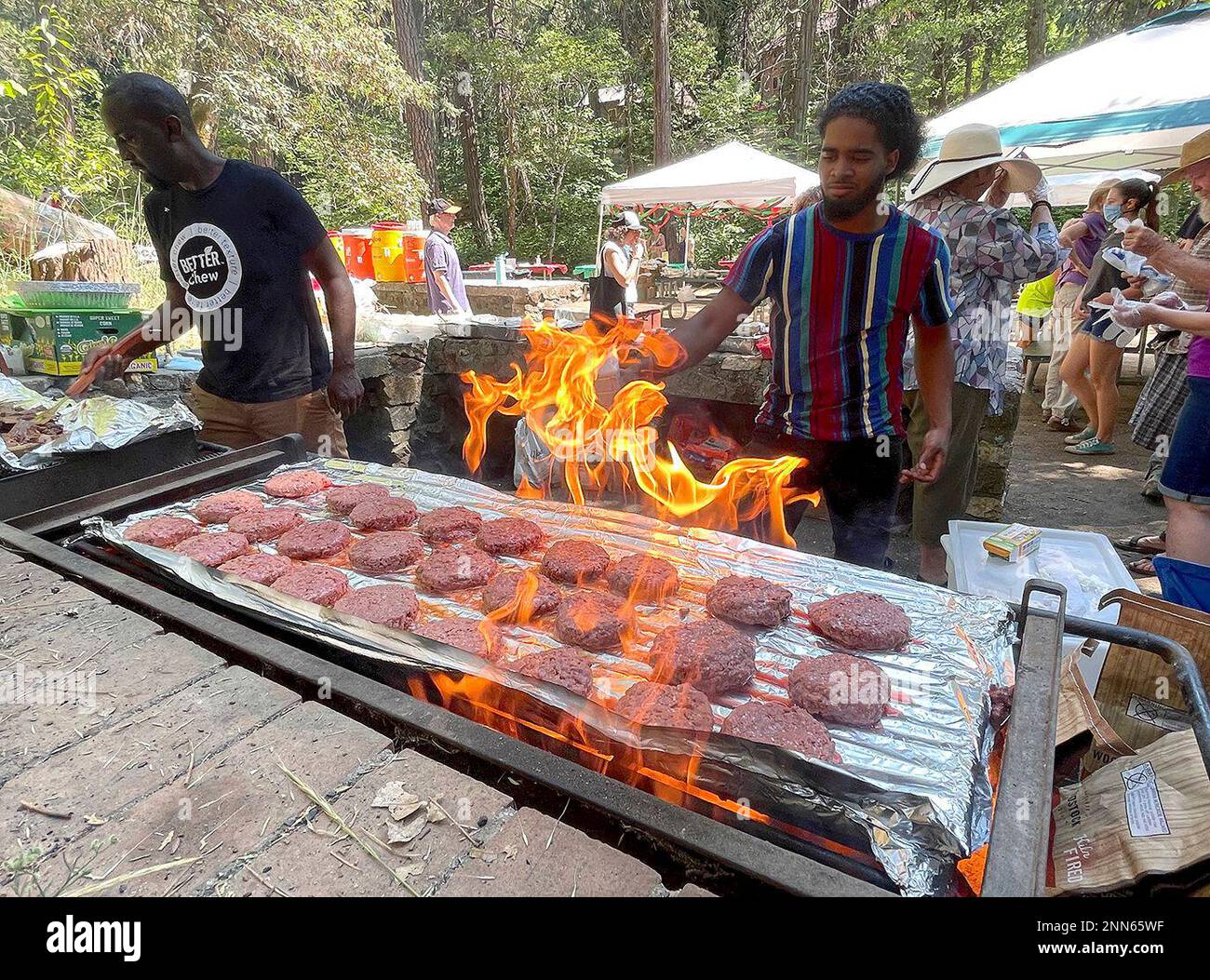 Marlon Cook fires up the beyond meat burgers on the grill during ...