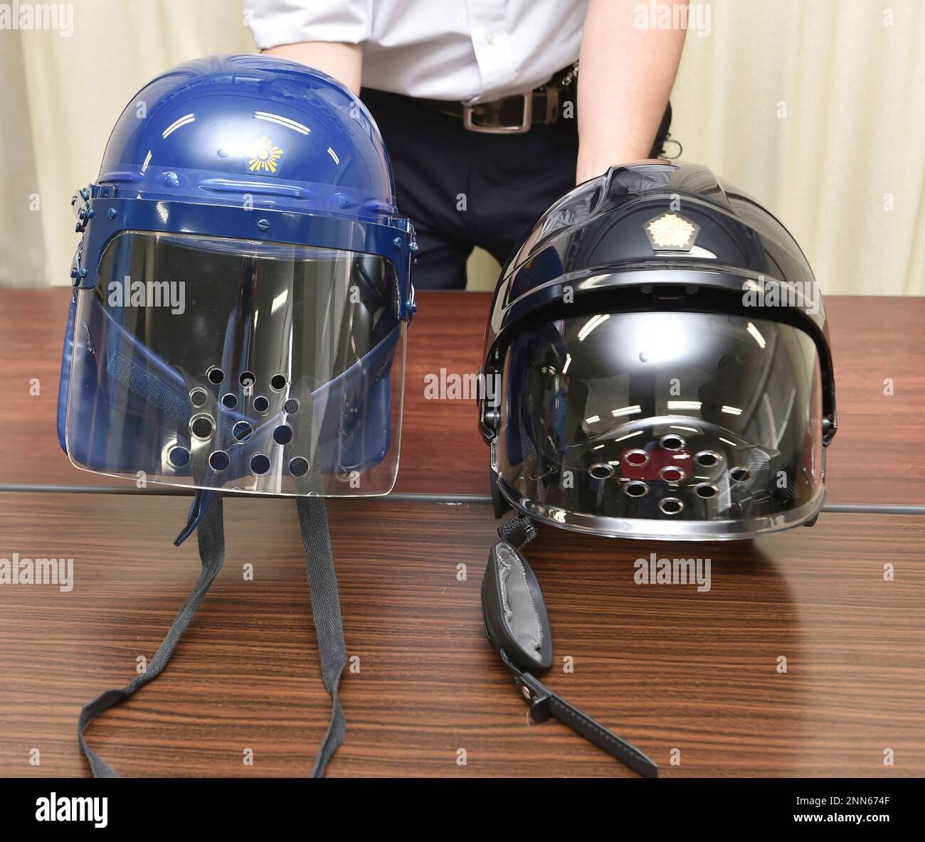 Old(L) and new types of helmets for Tokyo Metropolitan Police ...
