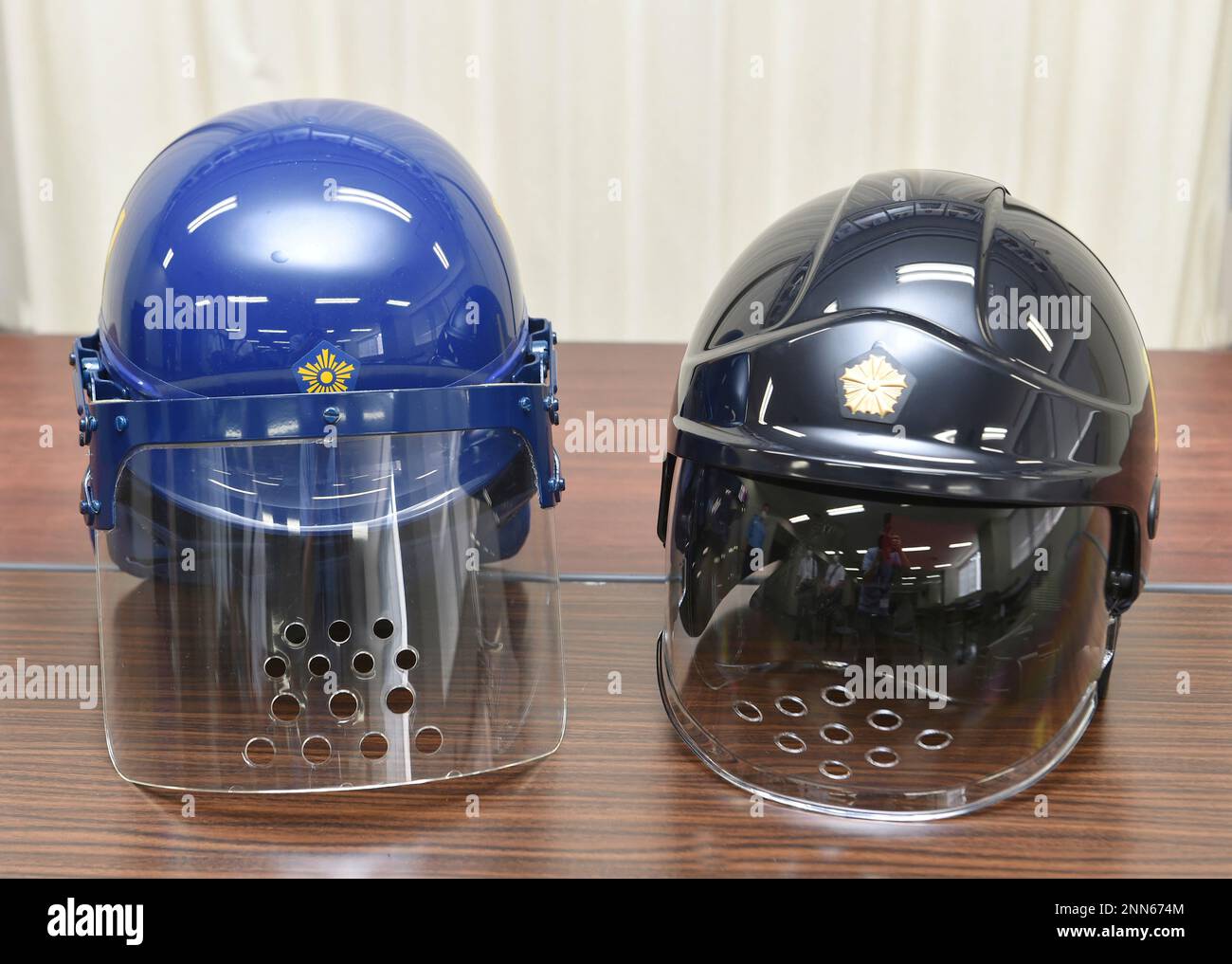 Old(L) and new types of helmets for Tokyo Metropolitan Police ...
