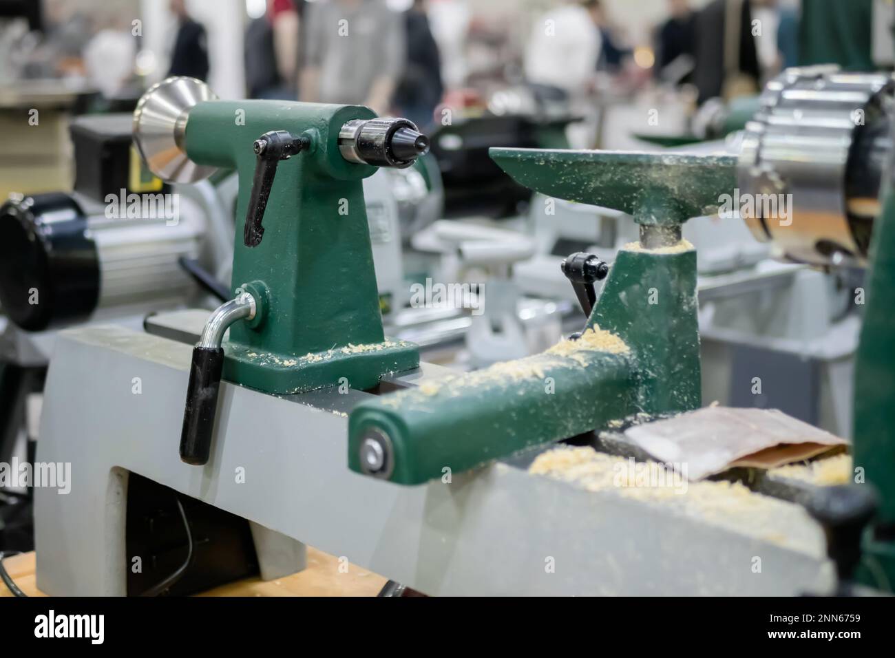 Close up view: wood turning lathe machine with shavings at workshop ...