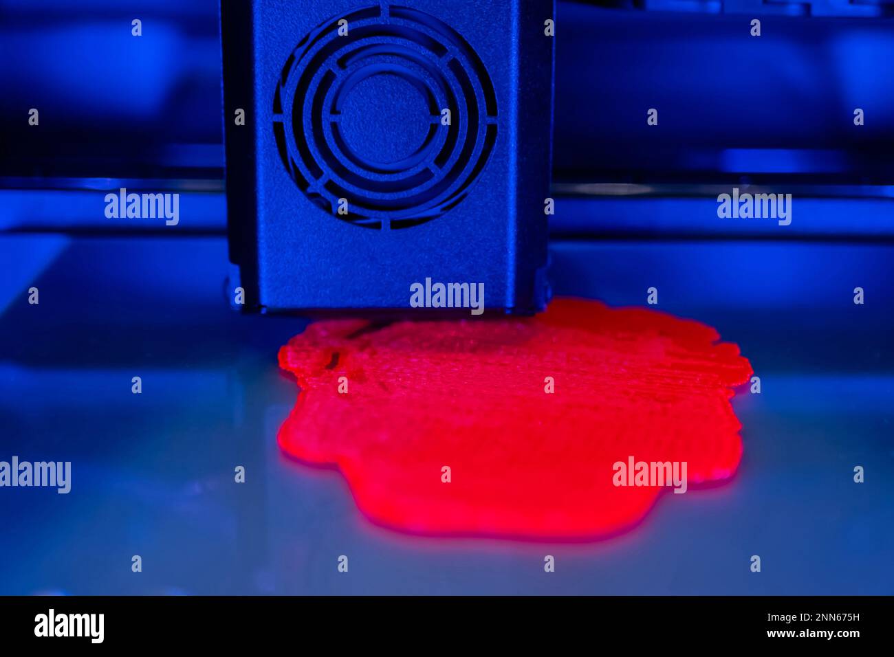 3D printer making physical red 3D model with plastic wire filament ...