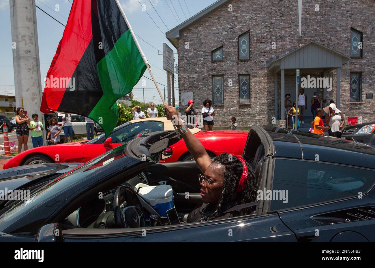 Savannah Taplin waves a Pan-African flag, also known as the Black ...
