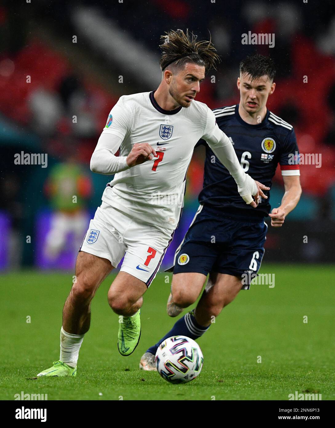 England's Jack Grealish, left, and Scotland's Kieran Tierney challenge ...