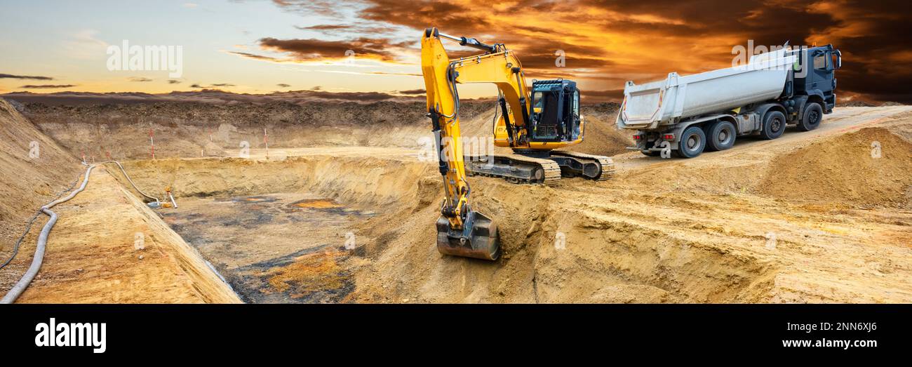 excavator is working and digging at construction site Stock Photo - Alamy