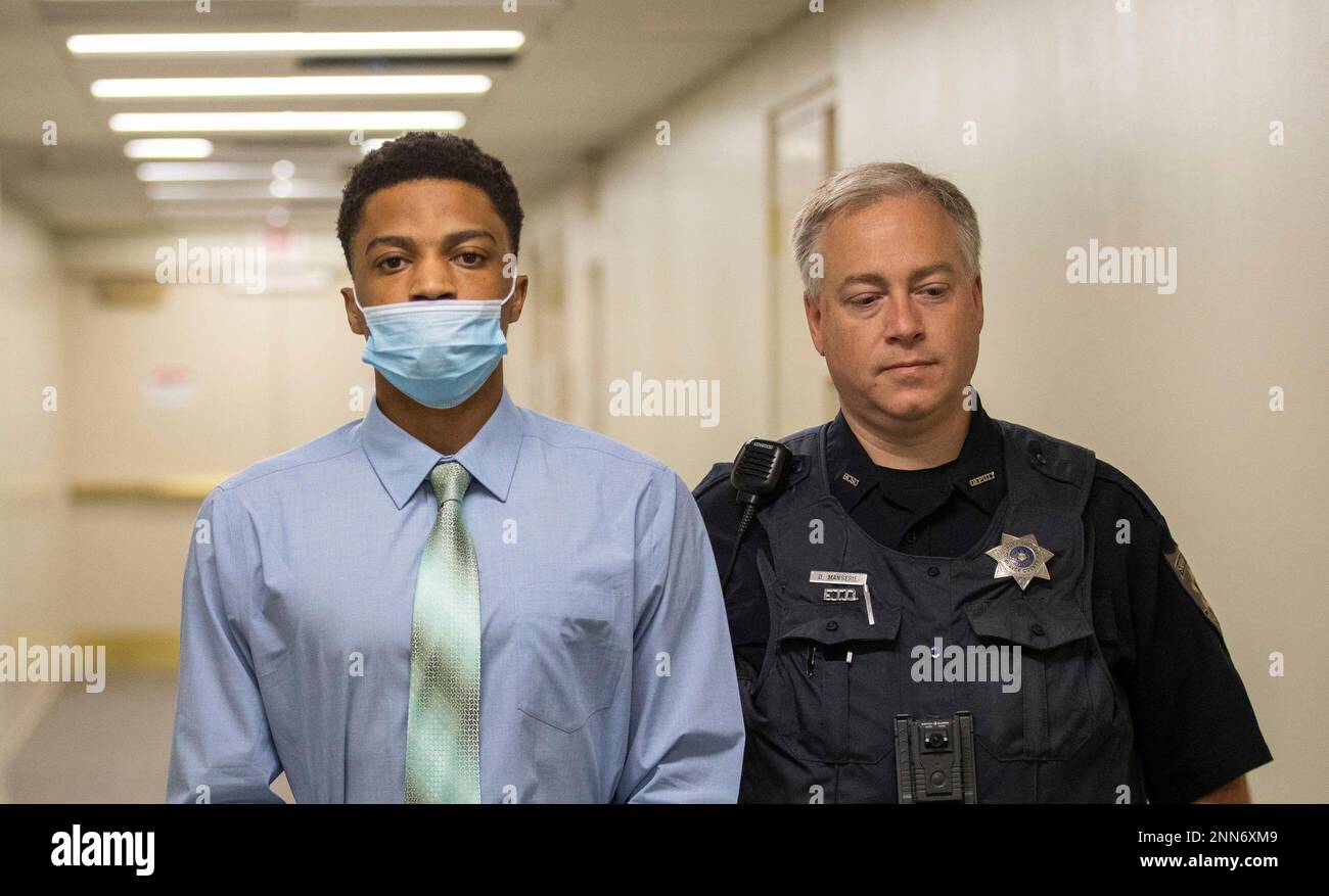 Sheldon Jeter Jr., 23, of Aliquippa, is lead to a courtroom at the ...