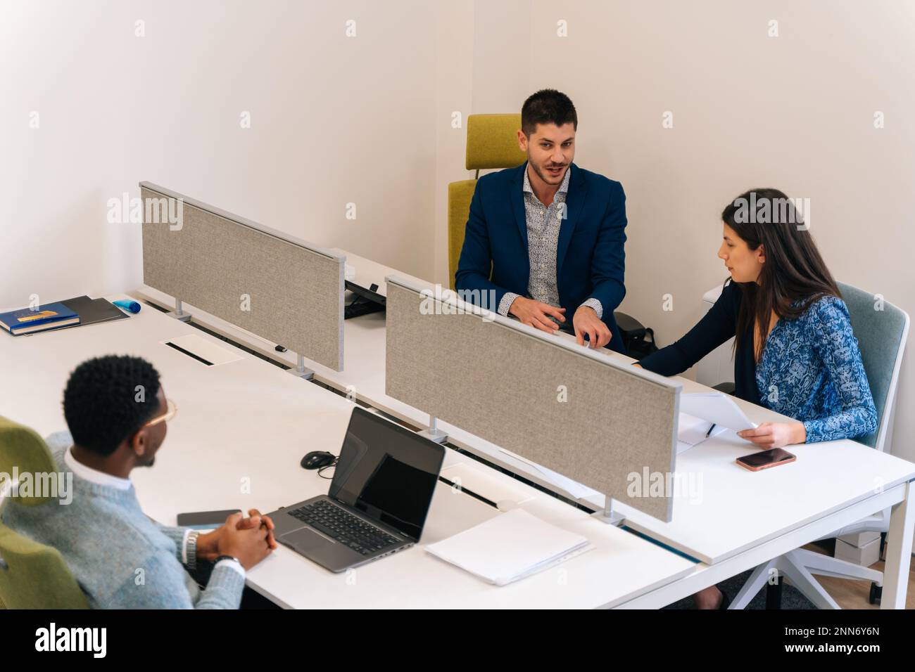 A group of colleagues having a conversation while working Stock Photo ...