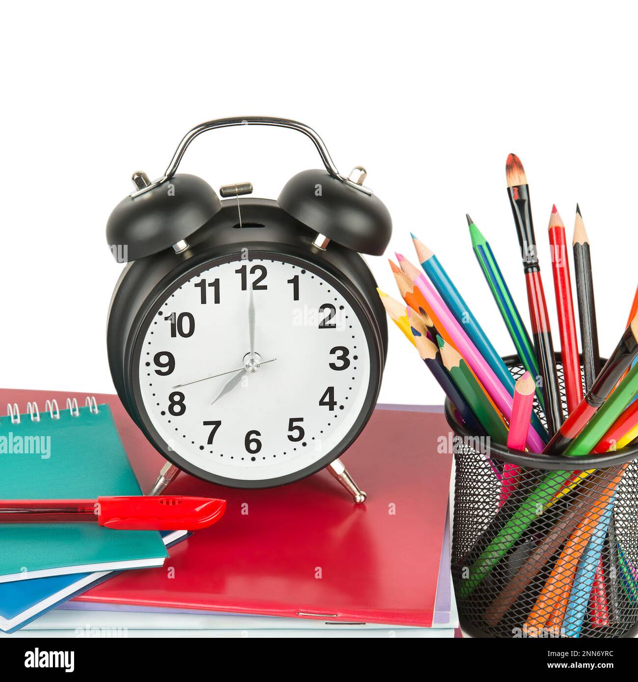 School supplies and alarm clock isolated on white background. Concept ...