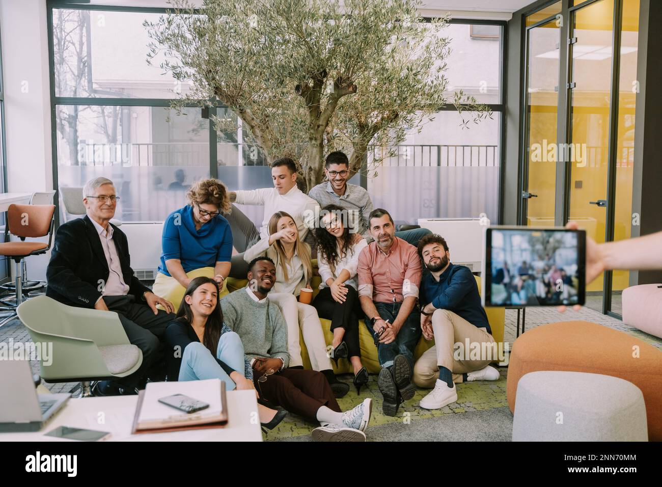 Coworkers creating beautiful memories at work. They are posing for ...