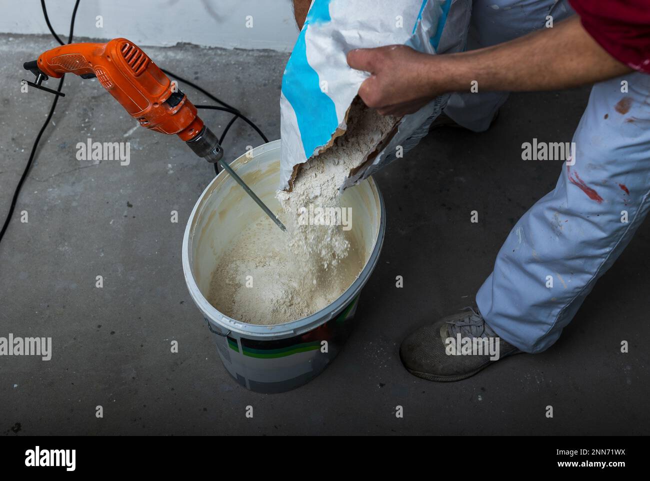 Craftsman mixing materials for wall renovation plaster Stock Photo - Alamy