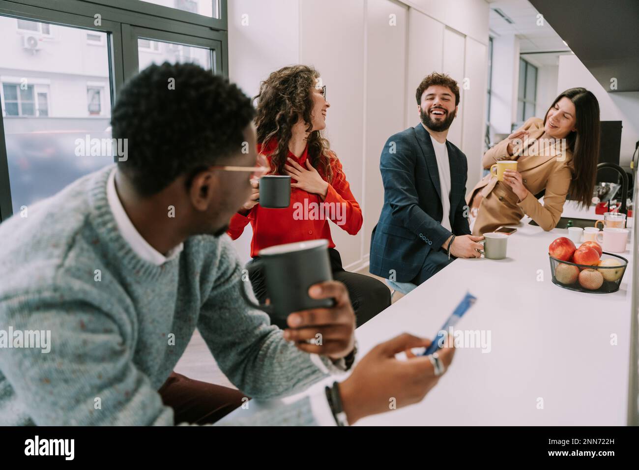 Multiracial colleagues taking a break from work. They are having a ...