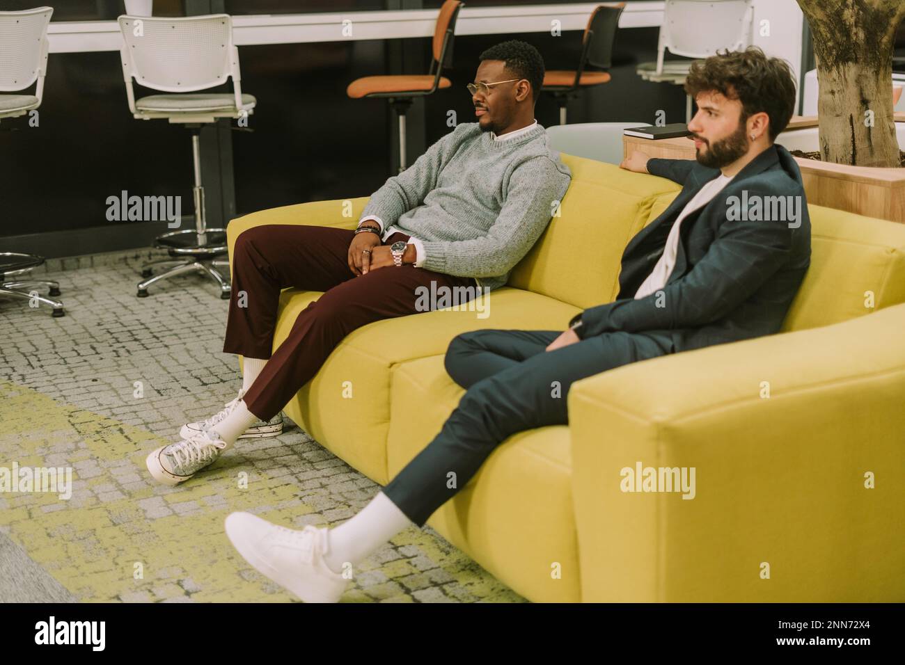 Multiracial coworkers taking a break from work at modern office. They ...