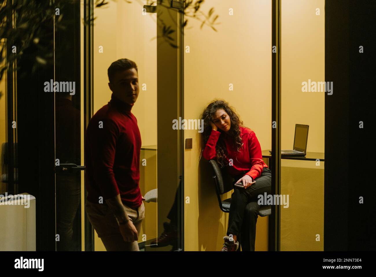 Young sad coworkers had a conversation with their partners in the phone ...