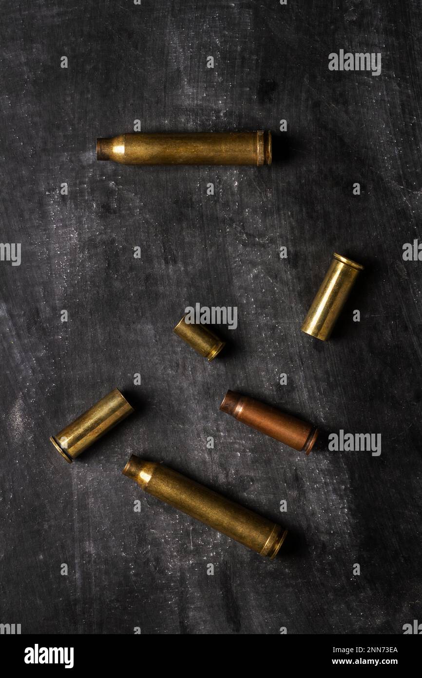 Empty bullet cartridges lying on the black background Stock Photo - Alamy