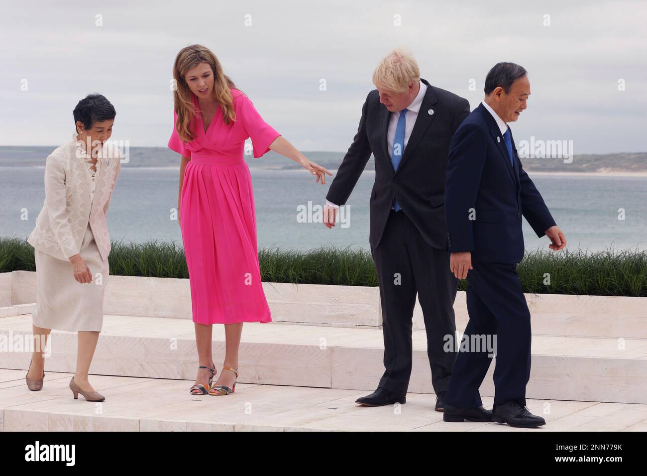 Japanese Prime Minister Yoshihide Suga and his wife Mariko are greeted ...