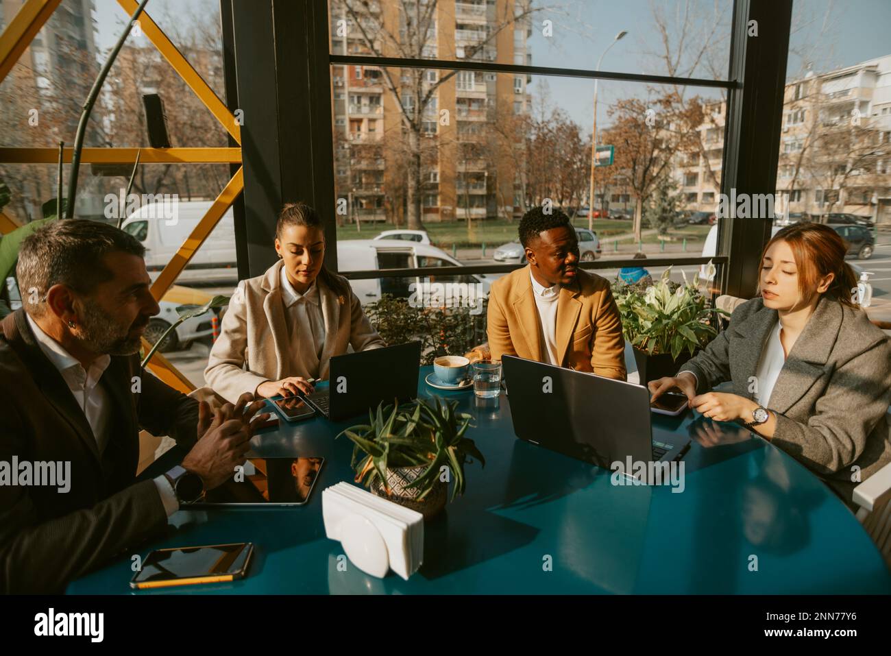 Four business people having a business meeting while sitting at the ...