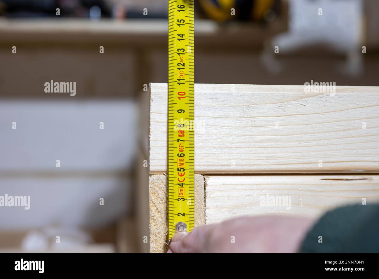 measuring the fixing points on a piece of lumber timber wood section ...