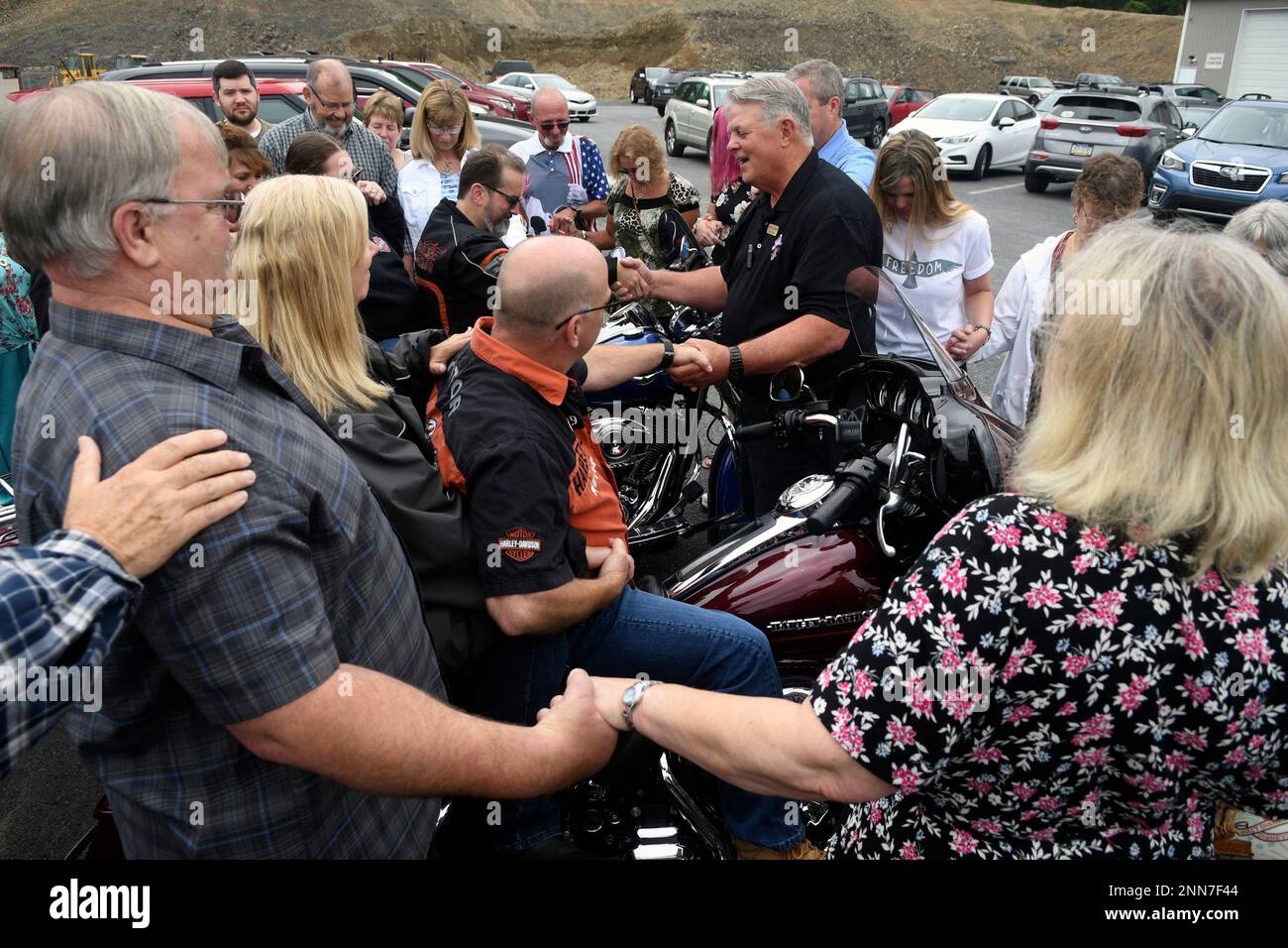 Pastor Doug Cresswell, center, holds the hands in prayer of bikers Greg ...