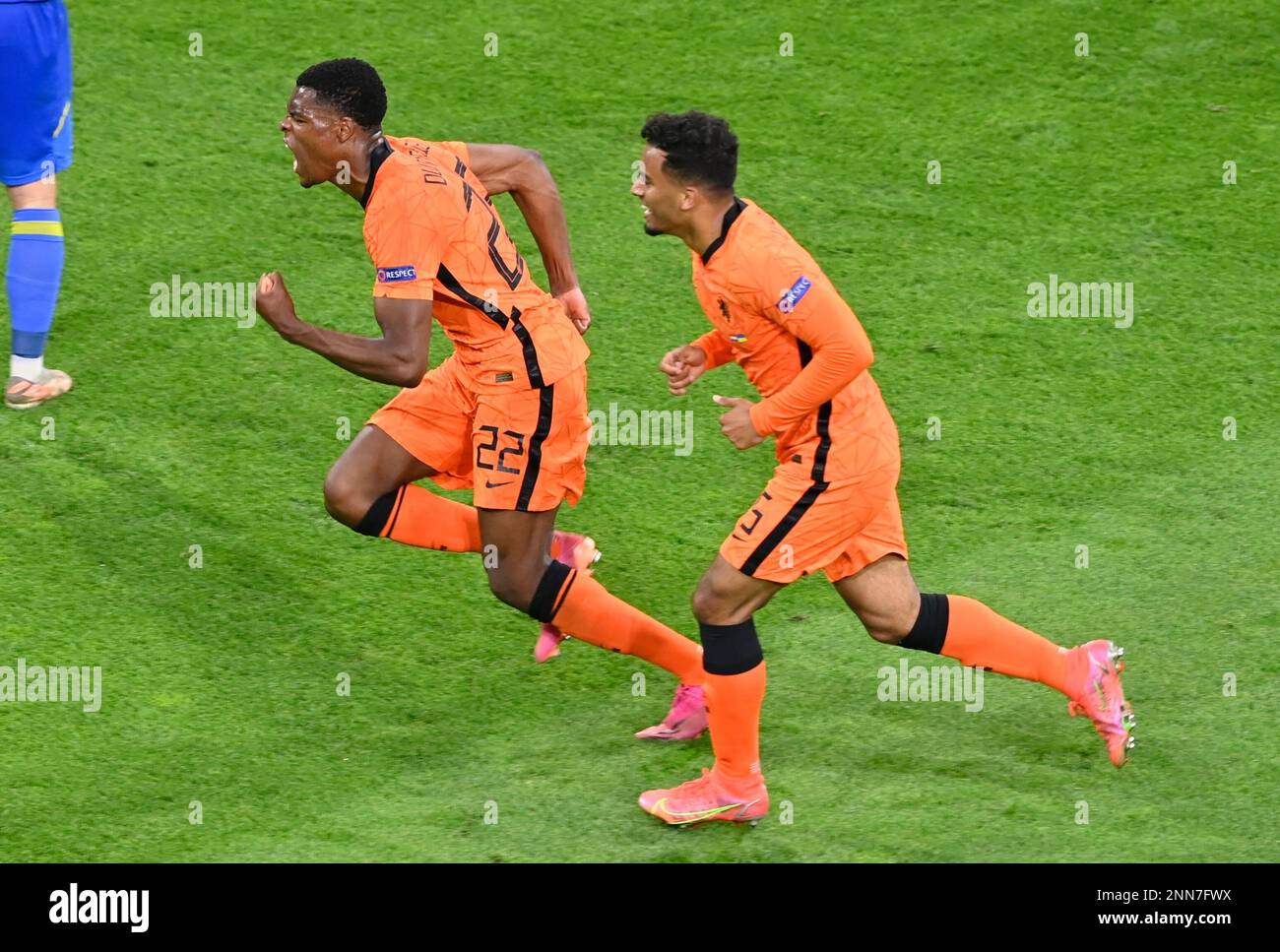 Netherlands' Denzel Dumfries, left, celebrates scoring their third goal ...