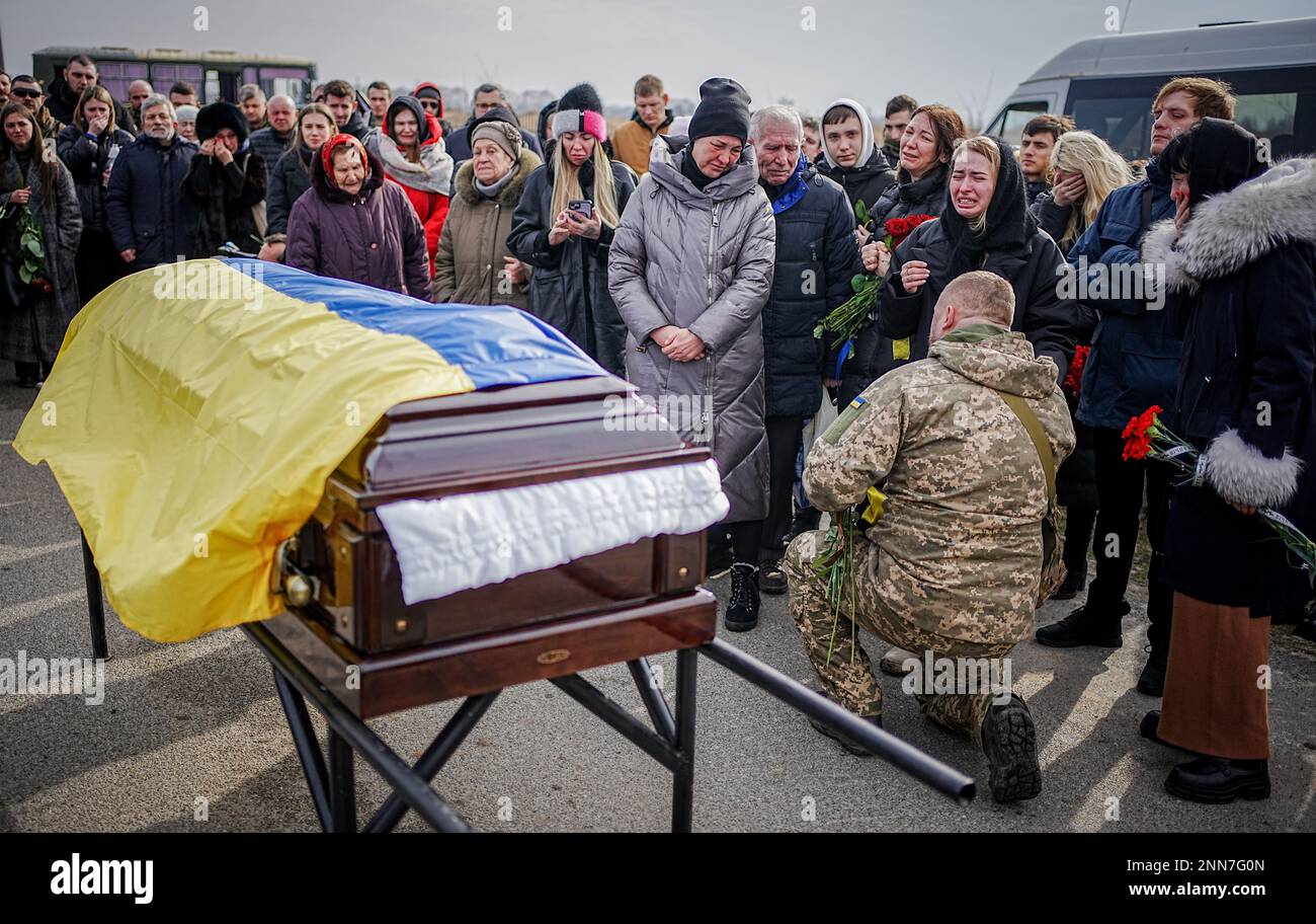 Butscha, Ukraine. 25th Feb, 2023. Comrades kneel down next to the ...