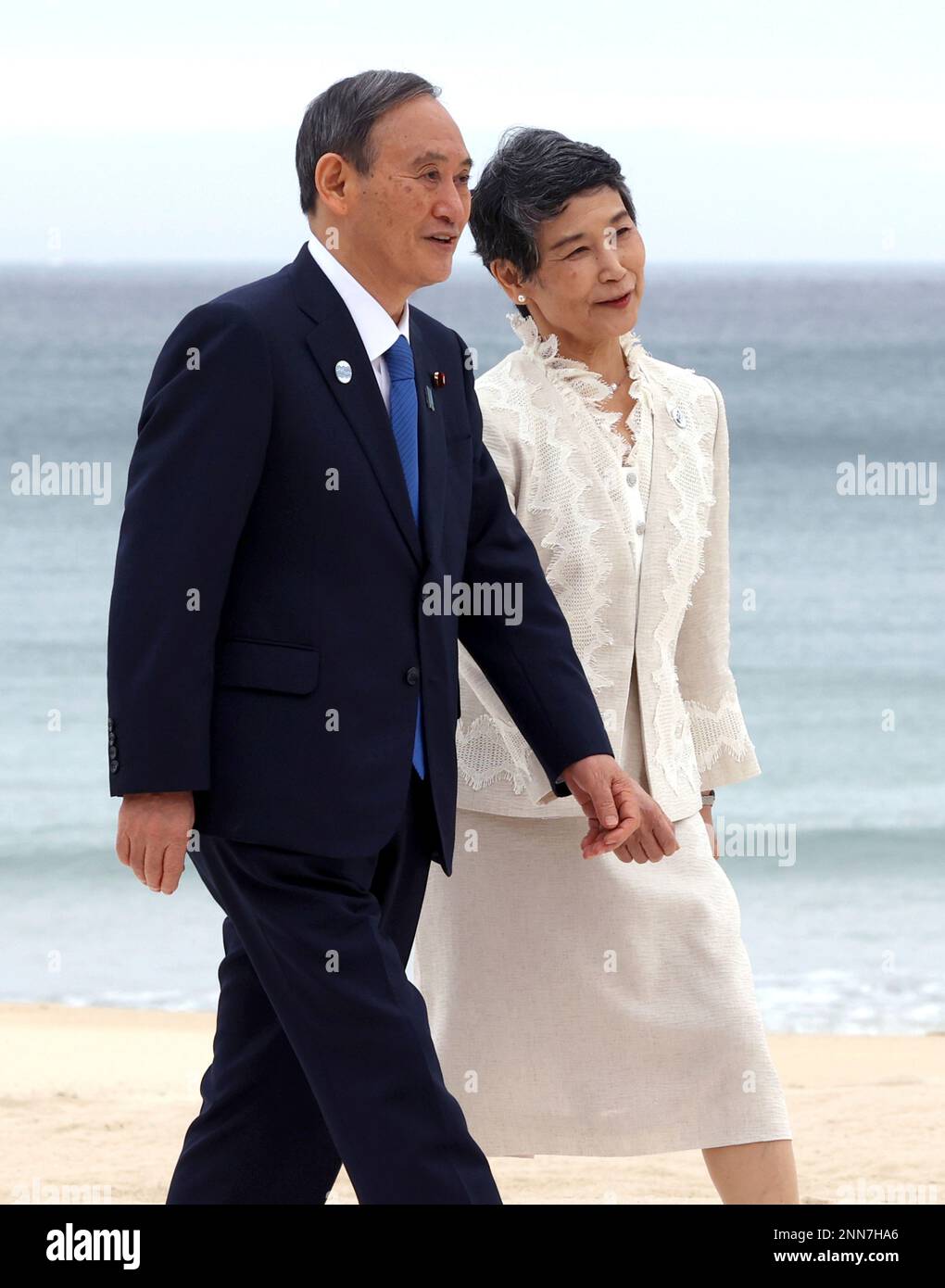 Japanese Prime Minister Yoshihide Suga and his wife Mariko head for the ...