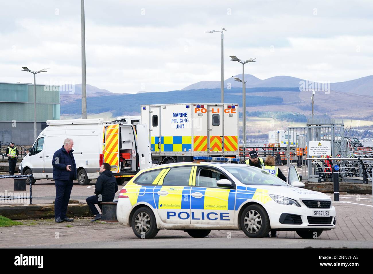 Police officers quayside during the rescue operation in the Firth of ...