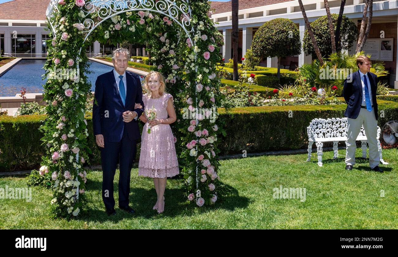 As their son, Christopher Nixon Cox stands at right, Edward Cox, left ...