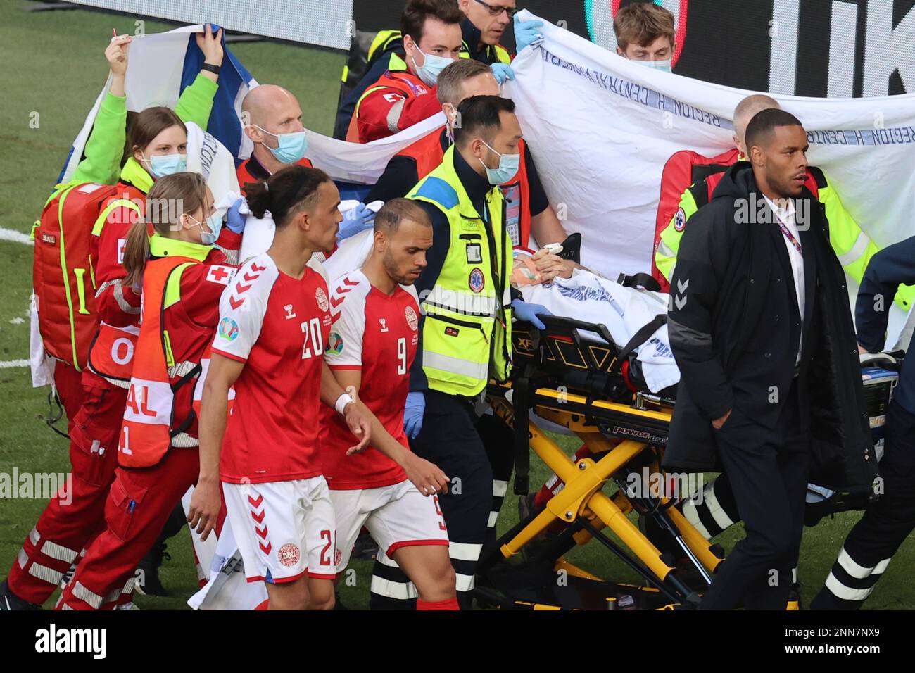 Paramedics using a stretcher to take out of the pitch Denmark's ...