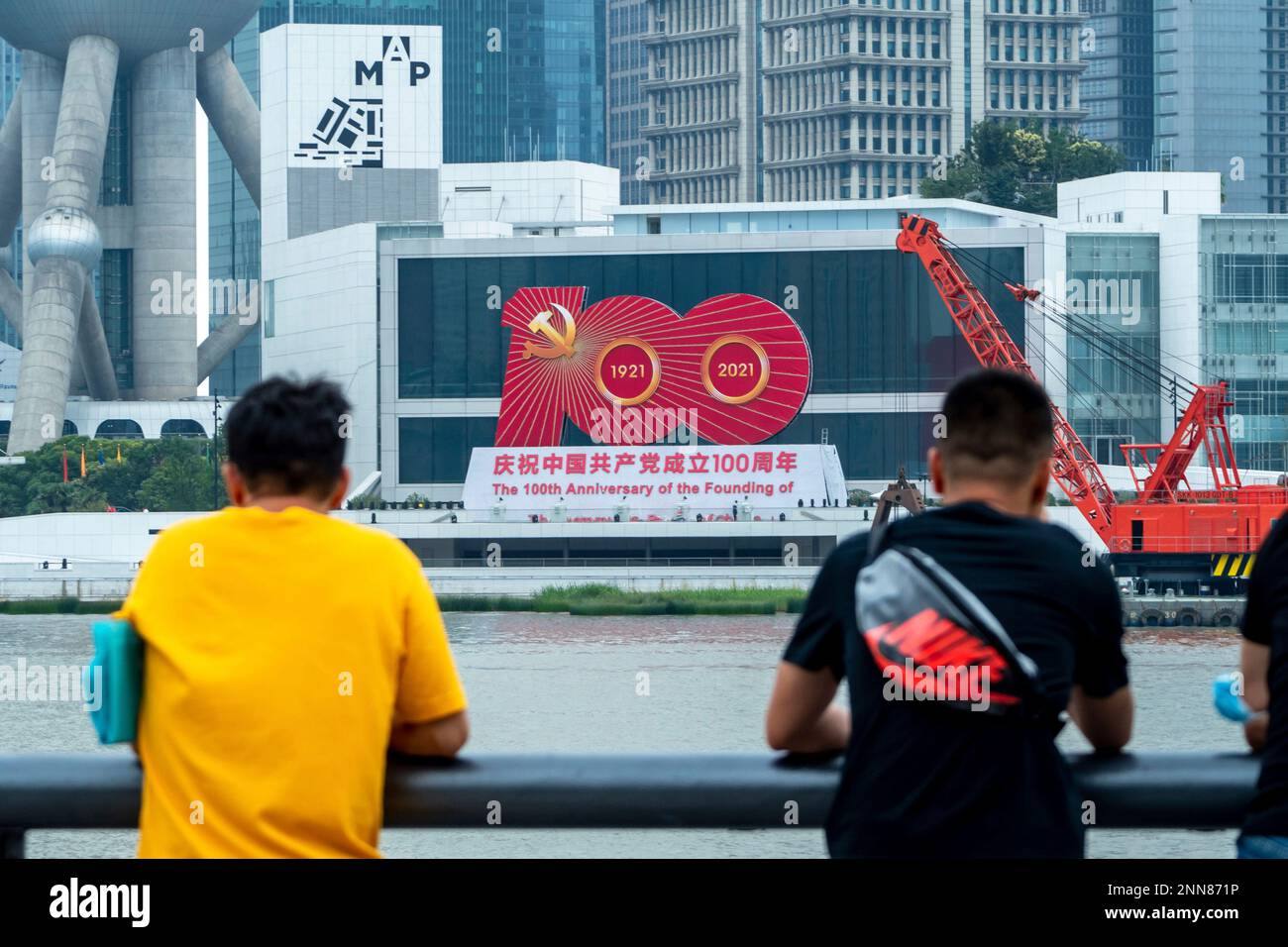 People watch the installing of a temporary setting to celebrate the ...