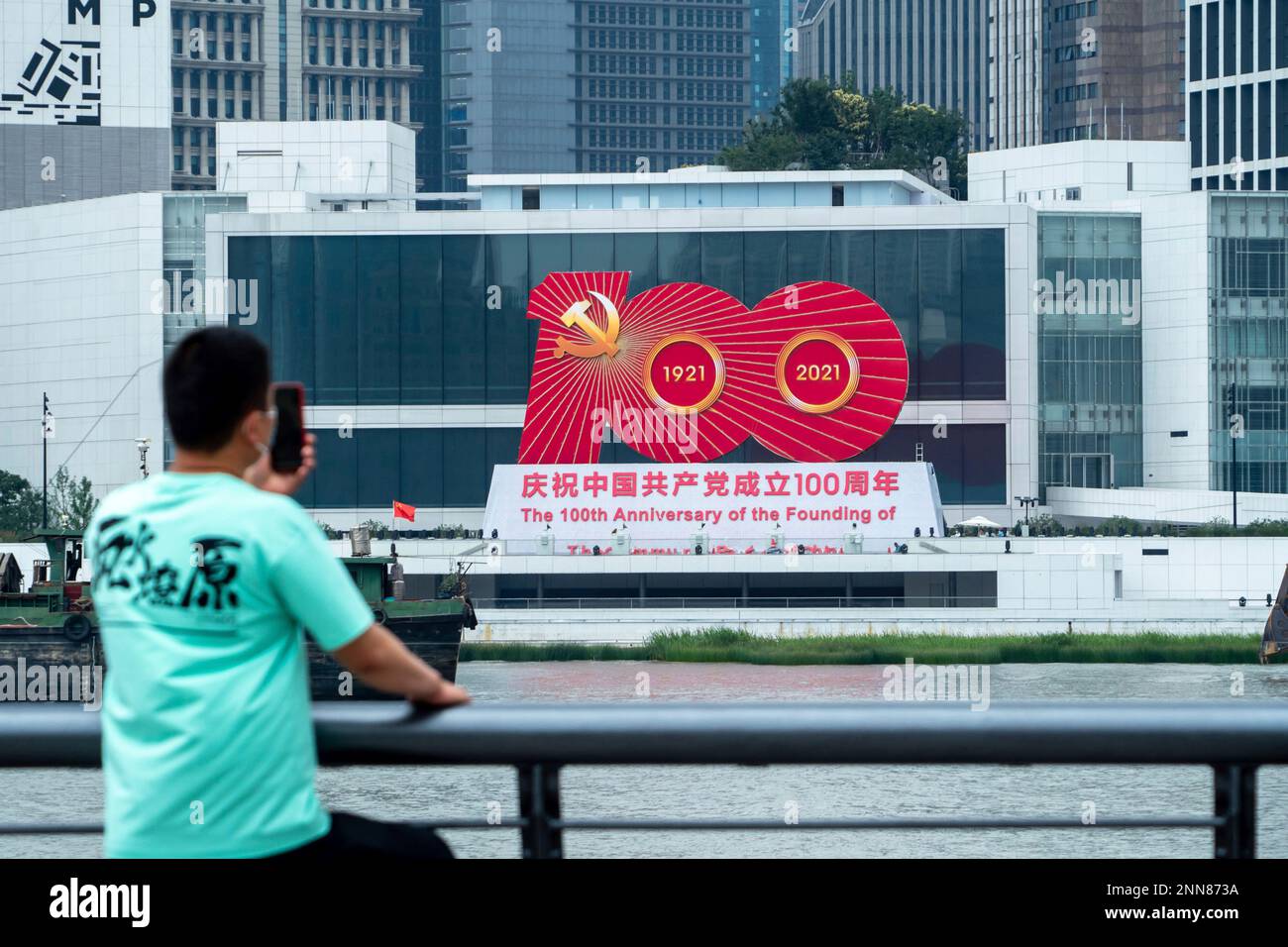A man takes photos of a temporary setting to celebrate the 100th ...