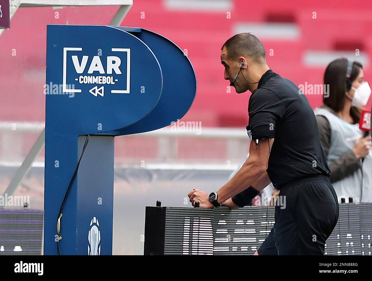 Referee Esteban Ostojich checks the VAR during a qualifying soccer ...