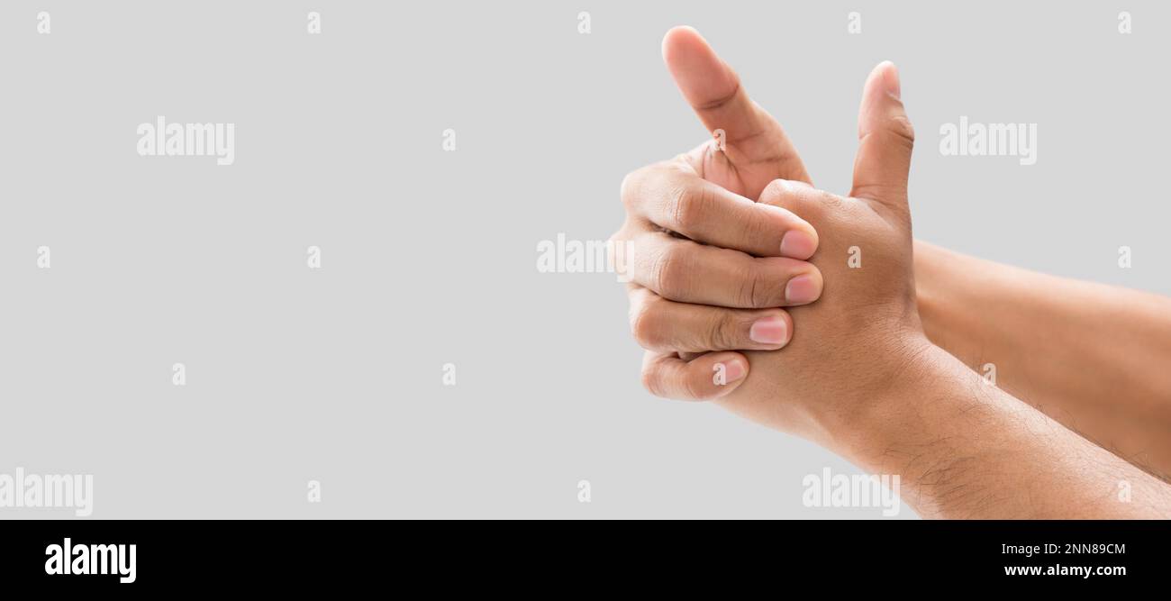 A man cracking their knuckles, On a gray background Stock Photo - Alamy