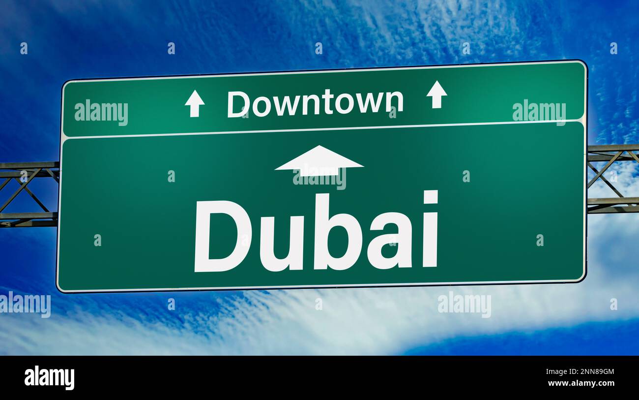 Road sign indicating direction to the city of Dubai Stock Photo - Alamy