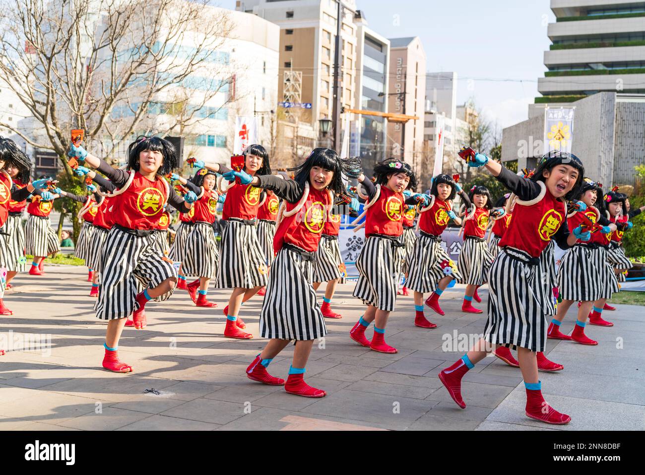 Japanese team of female child Yosakoi dancers dancing and holding ...