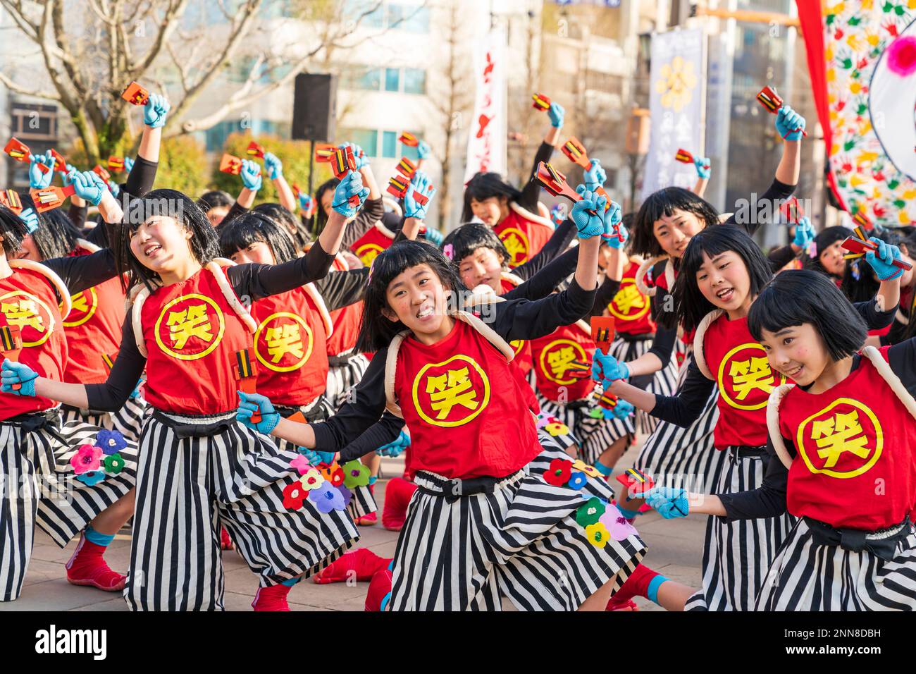 Japanese team of female child Yosakoi dancers dancing and holding ...
