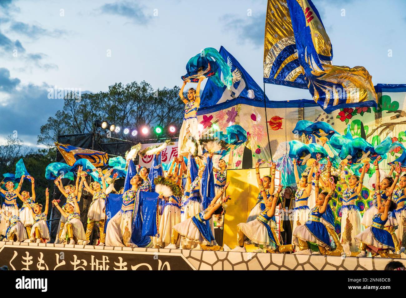 Japanese team of female Yosakoi dancers dancing in the evening on an ...