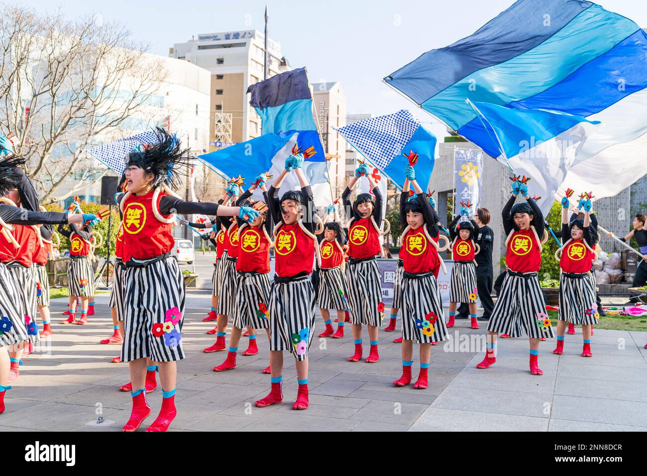 Japanese team of female child Yosakoi dancers dancing and holding ...